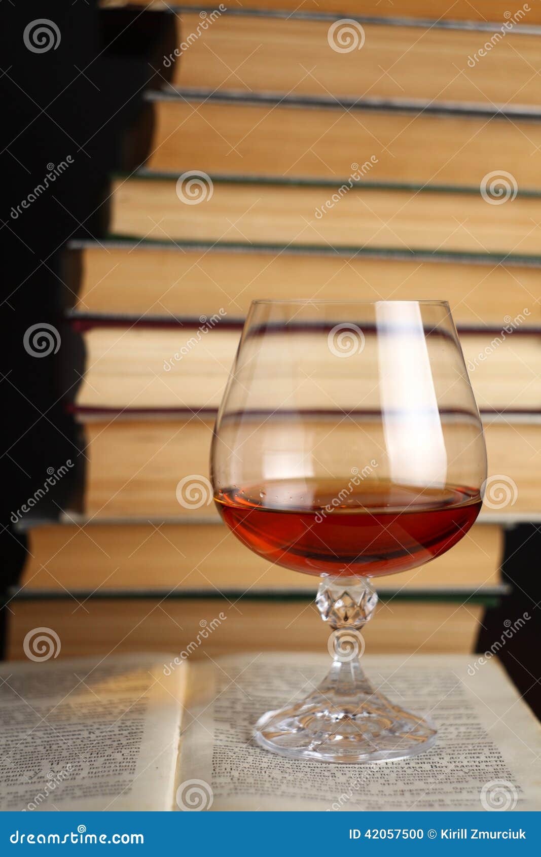 Glass of brandy on books stock photo. Image of advertising - 42057500