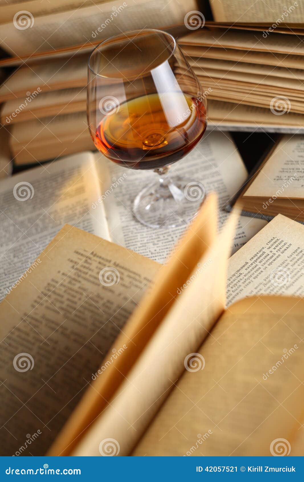 Glass of brandy on books stock image. Image of paper - 42057521