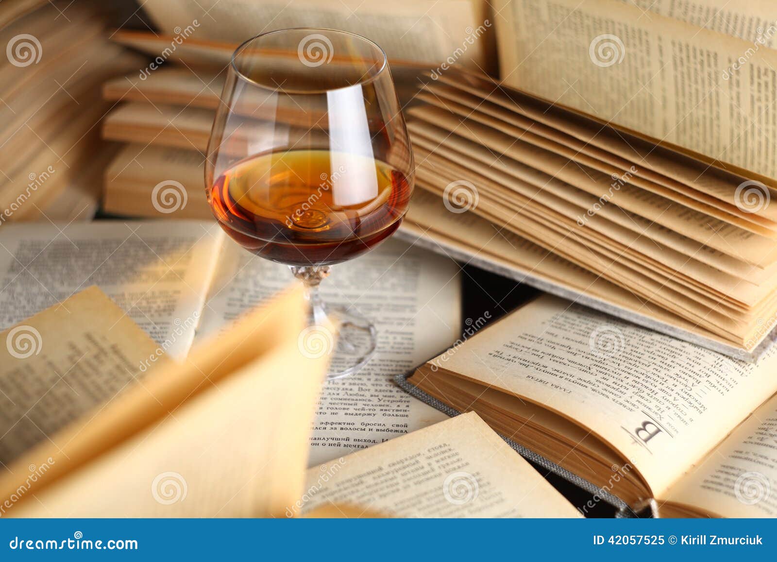 Glass of brandy on books stock image. Image of drink - 42057525