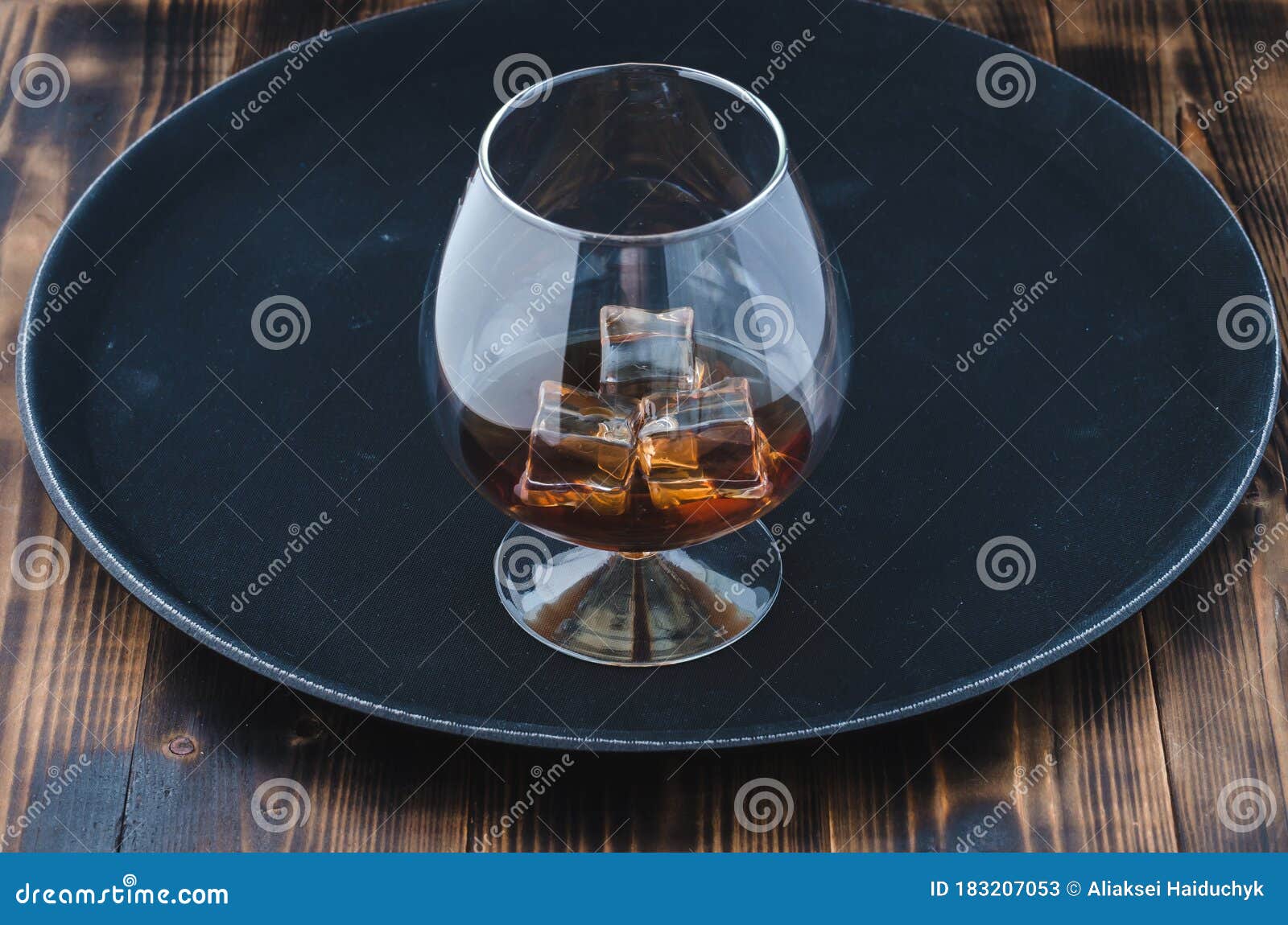 Glass of Brandy with Ice Cubes/Glass of Brandy with Ice Cubes on a ...