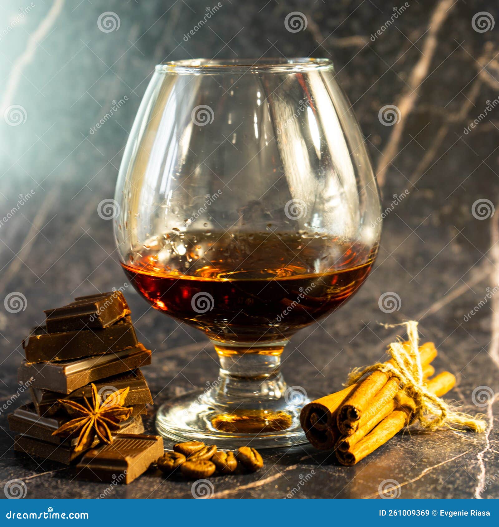 A Glass of Brandy on the Table with Chocolate, Cinnamon Sticks. Cognac ...
