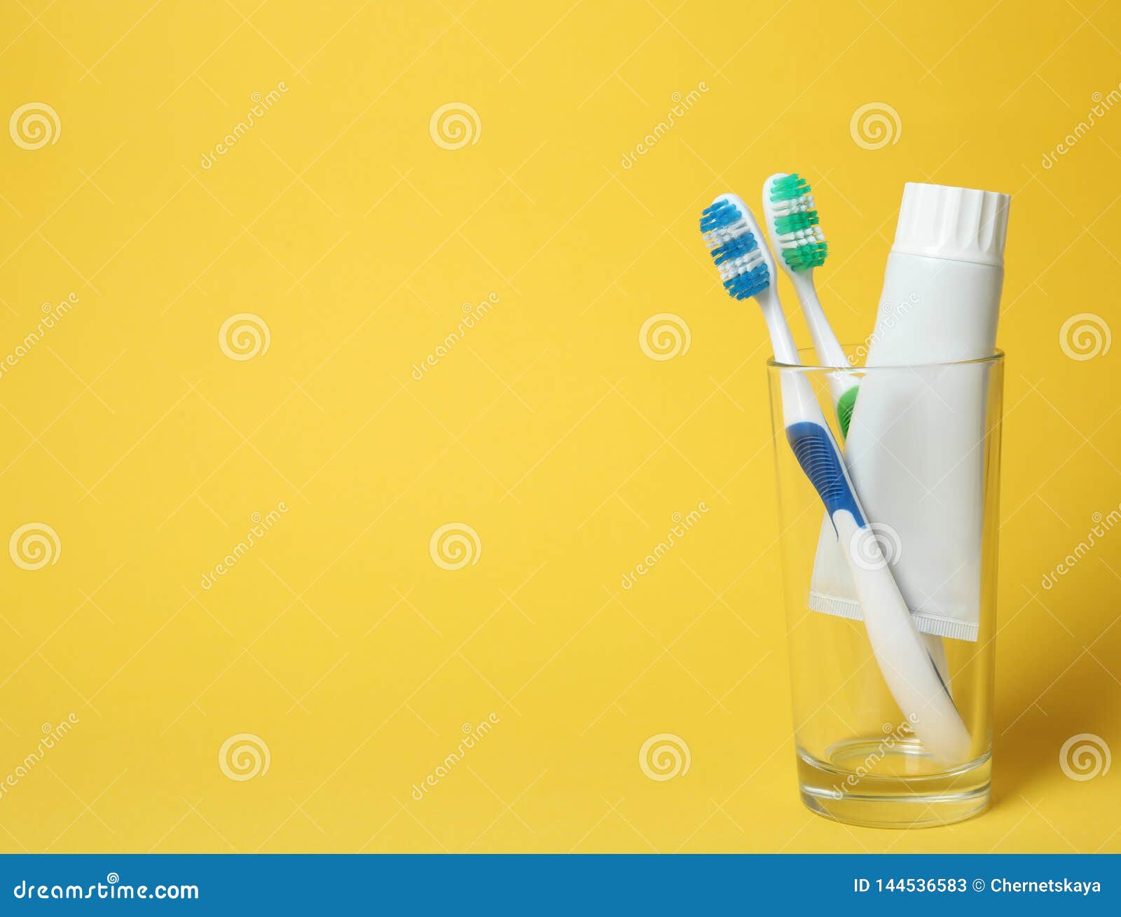 Glass with Brushes and Toothpaste on Color Background. Stock Image ...