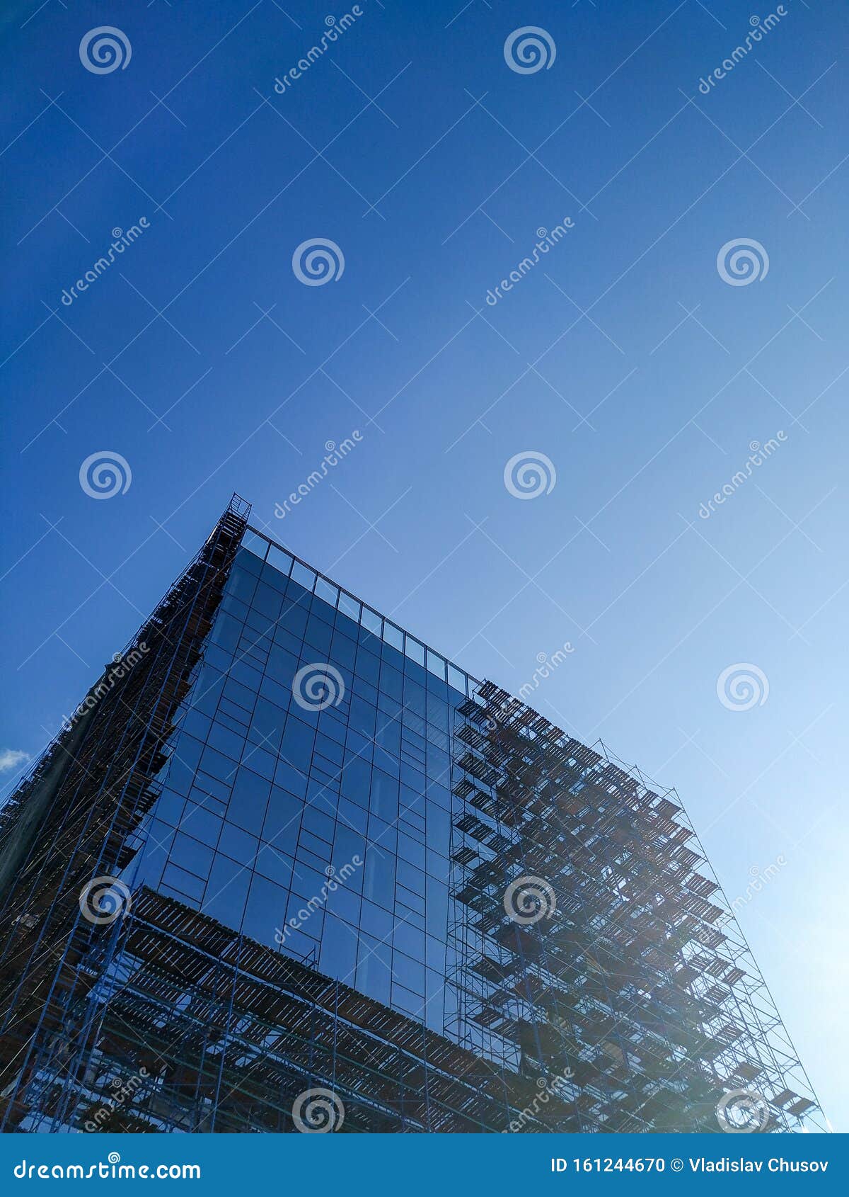 A Glass Building Under Construction. Blue Sky. Construction Stock Photo ...