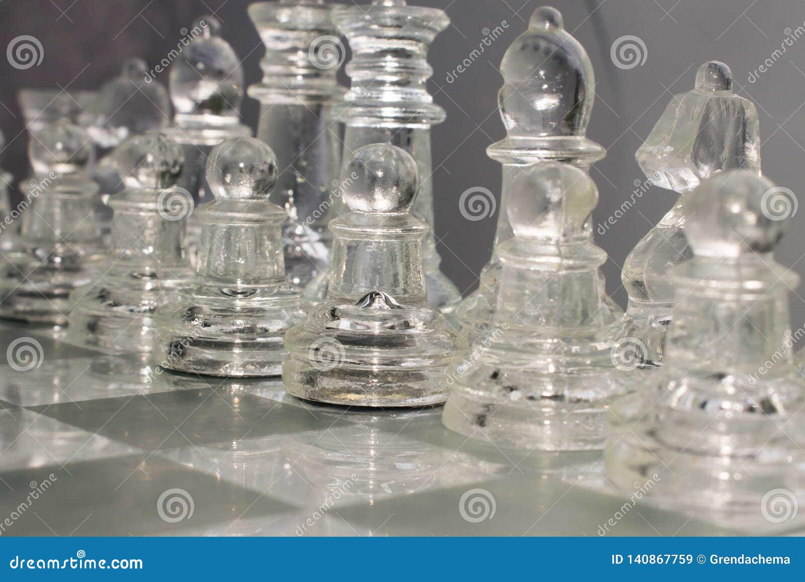 Glass Chess Pieces, Chess Pieces Arranged on a Glass Chess Board Stock ...