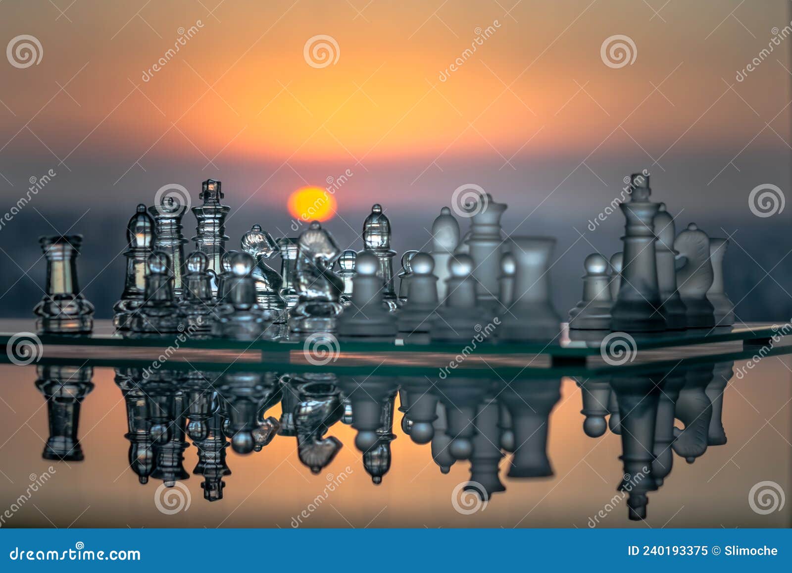 Reflected Glass Chess Pieces with a Sunset in the Background Stock ...