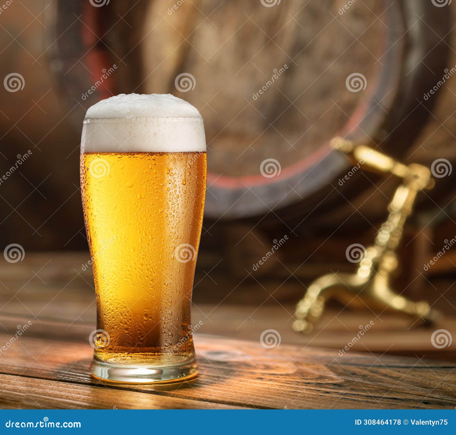 Glass of Chilled Beer and Wooden Beer Cask on the Background Stock ...