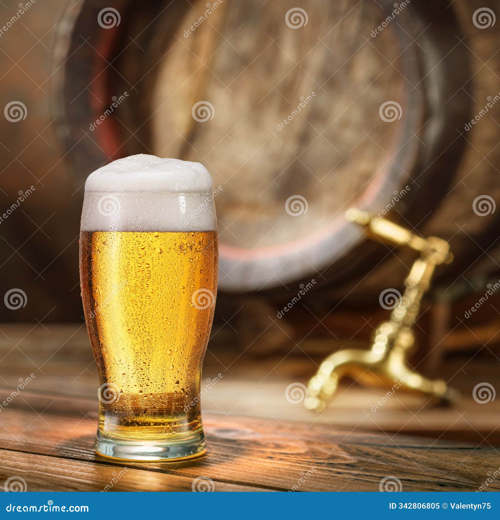 Glass of Chilled Beer and Wooden Beer Cask on the Background Stock ...