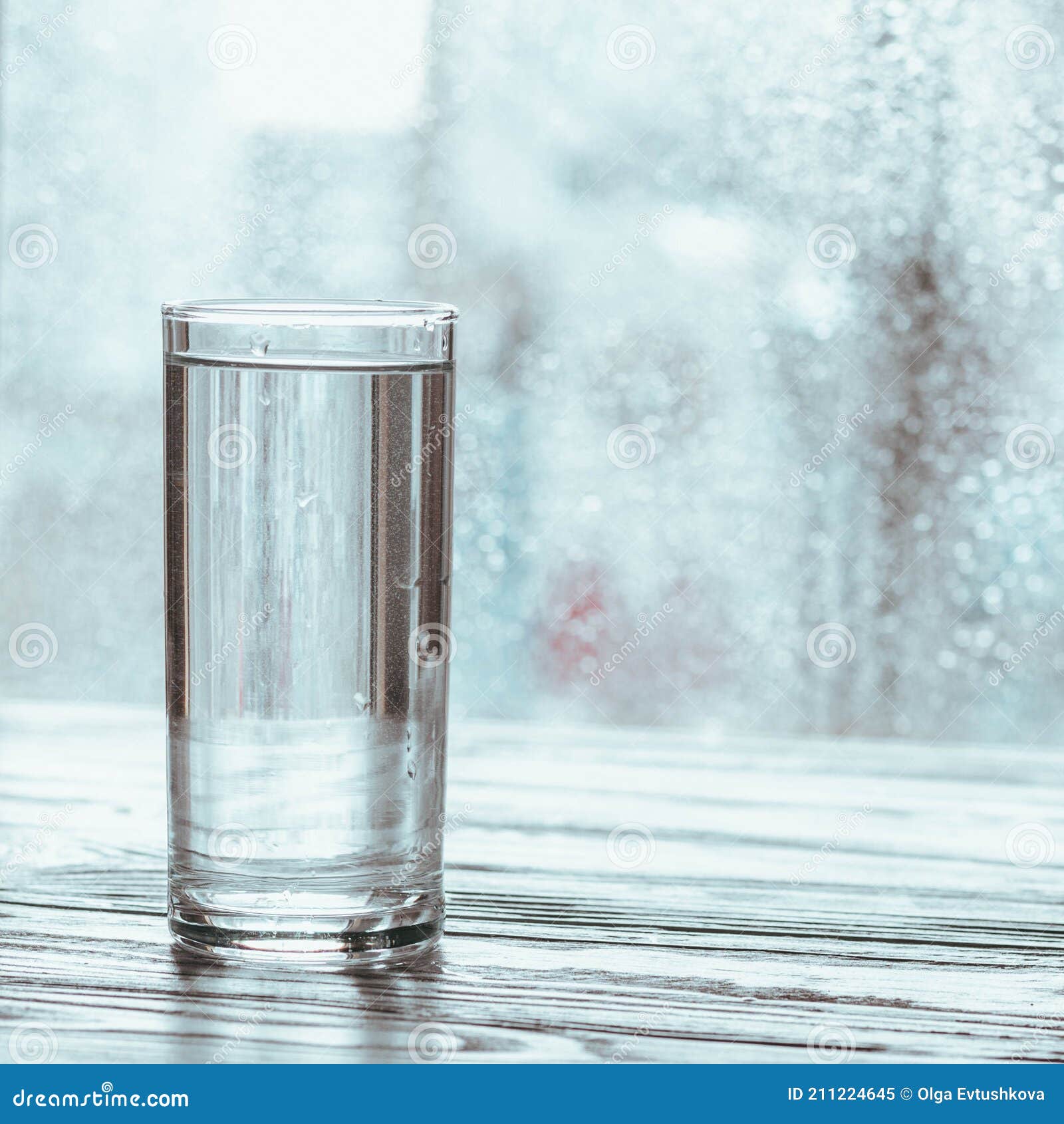 A Glass of Clear, Fresh, Clear Water is on the Table by the Window ...