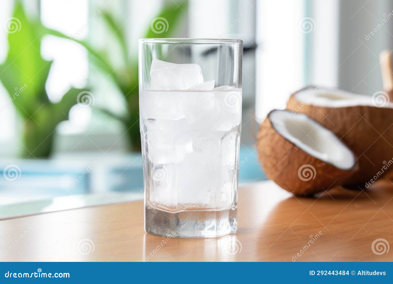 Glass of Coconut Water with Floating Ice Cubes on a Kitchen Counter ...