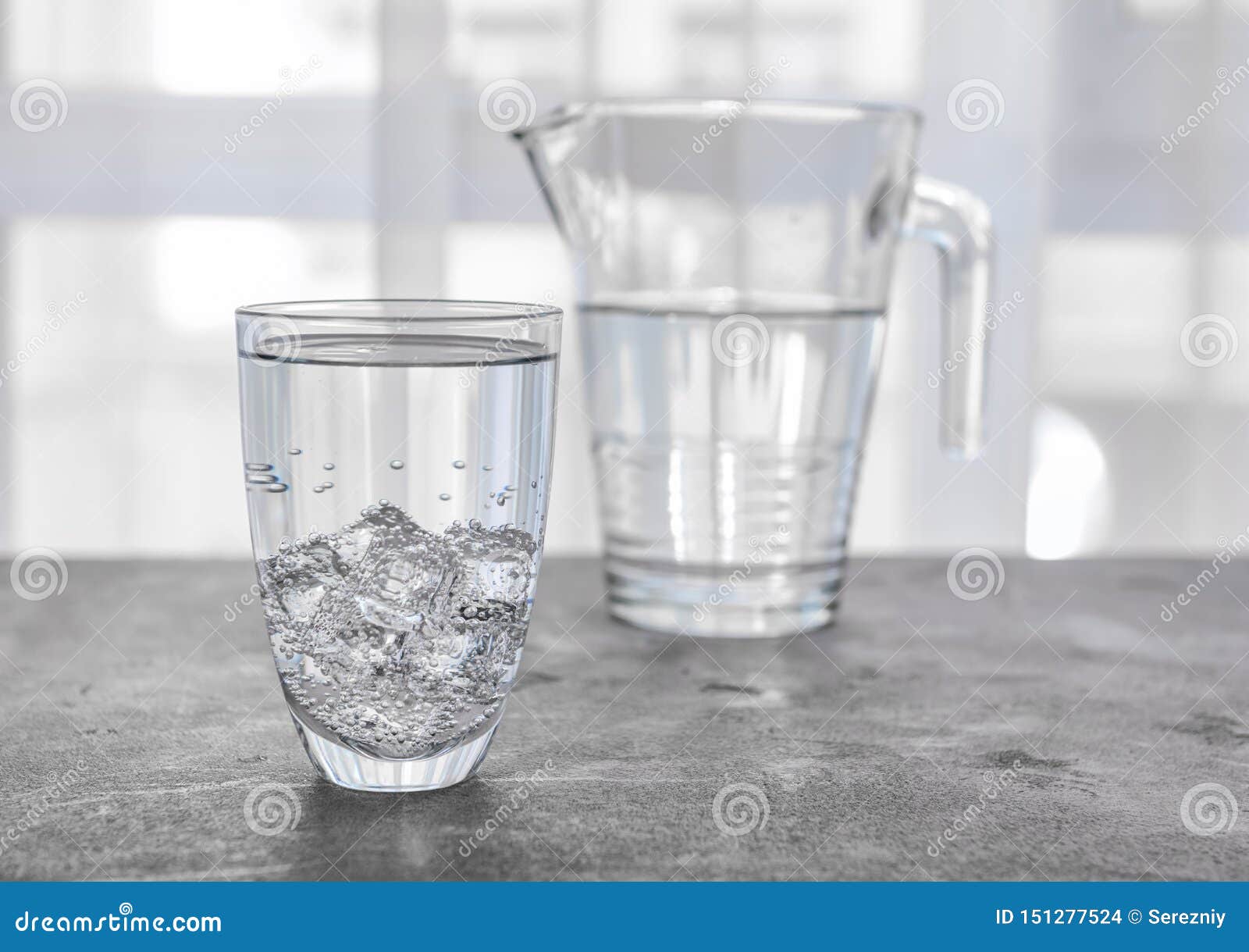 Glass of Cold Water with Ice Cubes on Grey Table Stock Photo - Image of ...