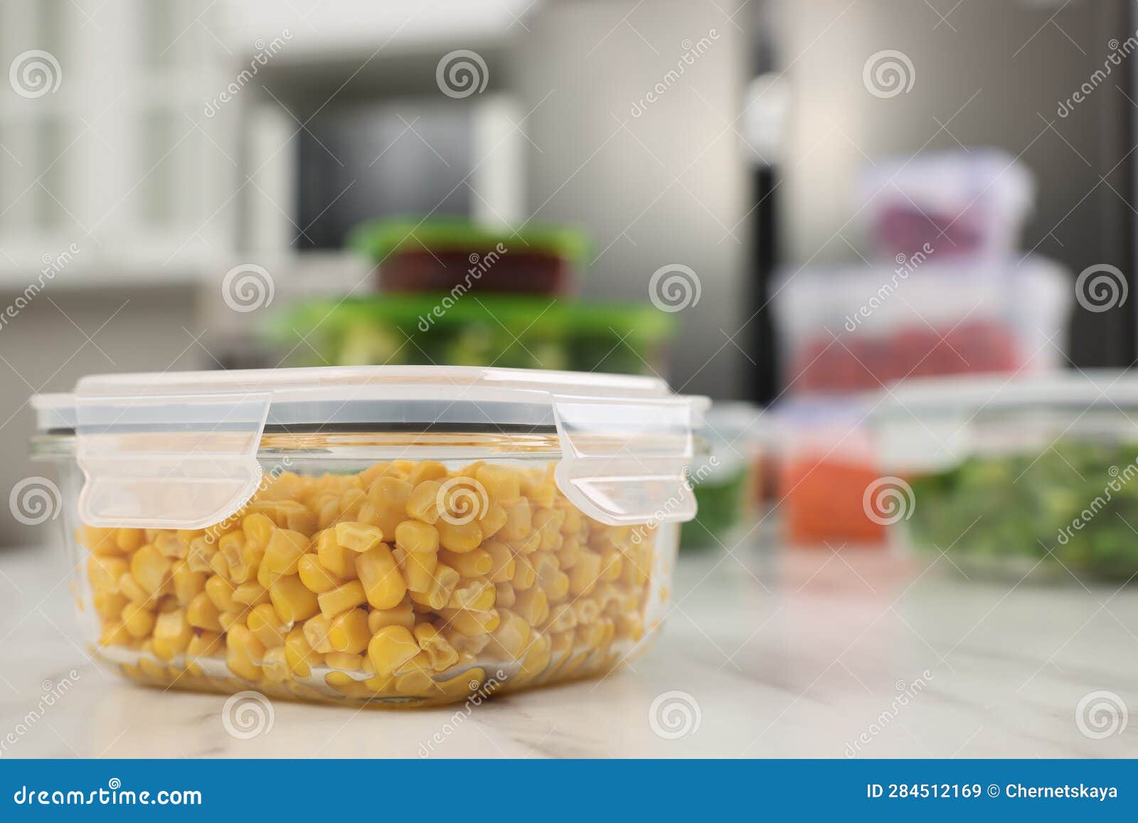 Glass Container with Tasty Corn Kernels on White Marble Table in ...