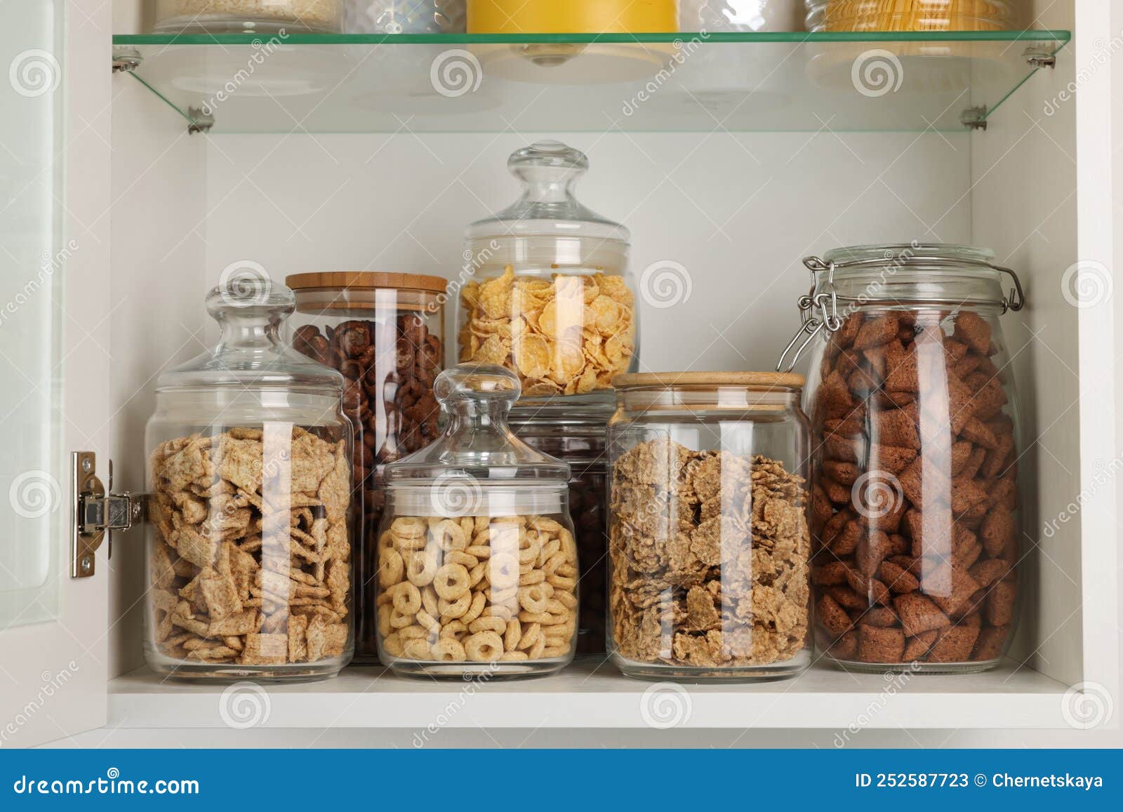 Glass Containers with Different Breakfast Cereals on Shelf Stock Image ...