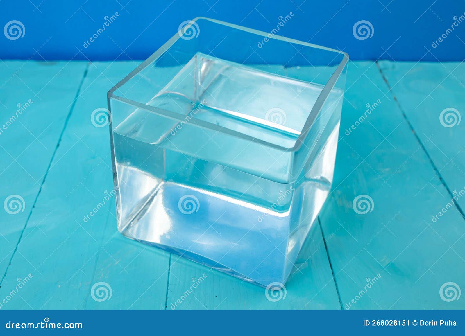 Glass Cube Filled with Water on Blue Background Stock Image - Image of ...