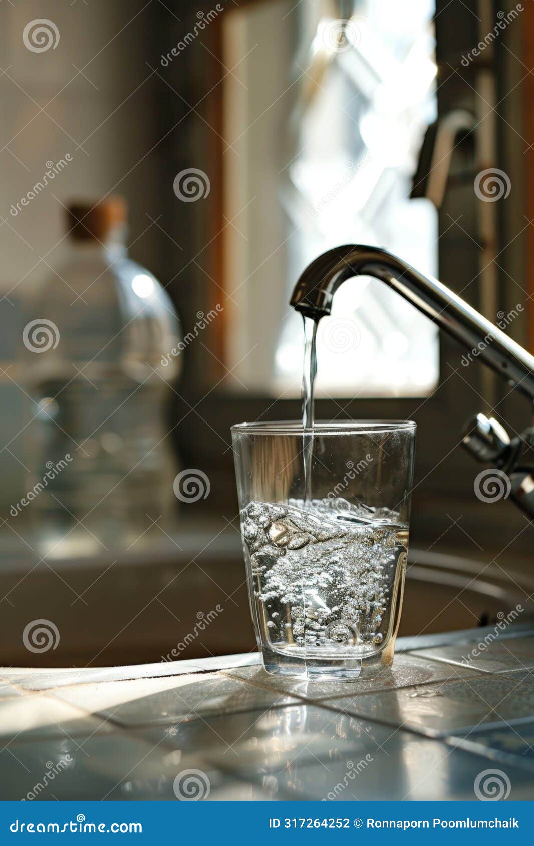 A Glass Cup Being Filled with Clean Water from a Tap in the Kitchen ...