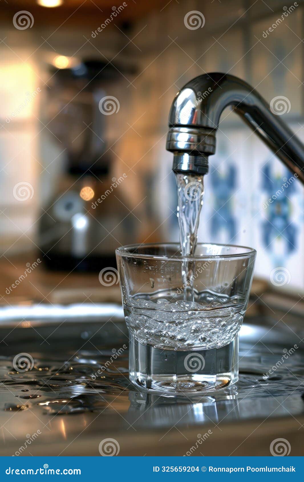 A Glass Cup Being Filled with Clean Water from a Tap in the Kitchen ...