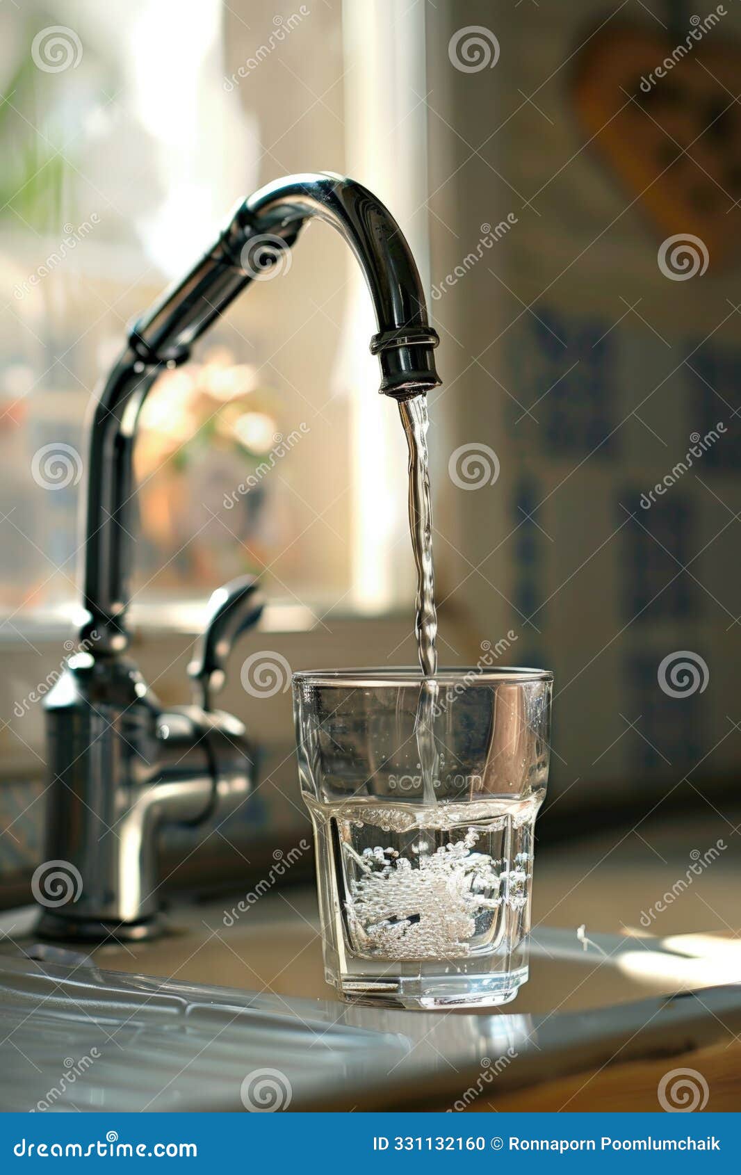 A Glass Cup Being Filled with Clean Water from a Tap in the Kitchen ...