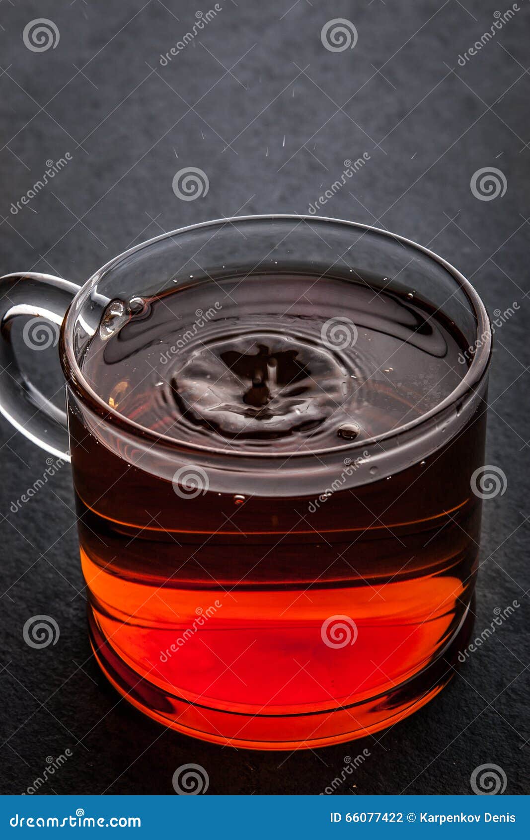 Glass Cup of Tea with Falling Drop Stock Photo - Image of vertical ...