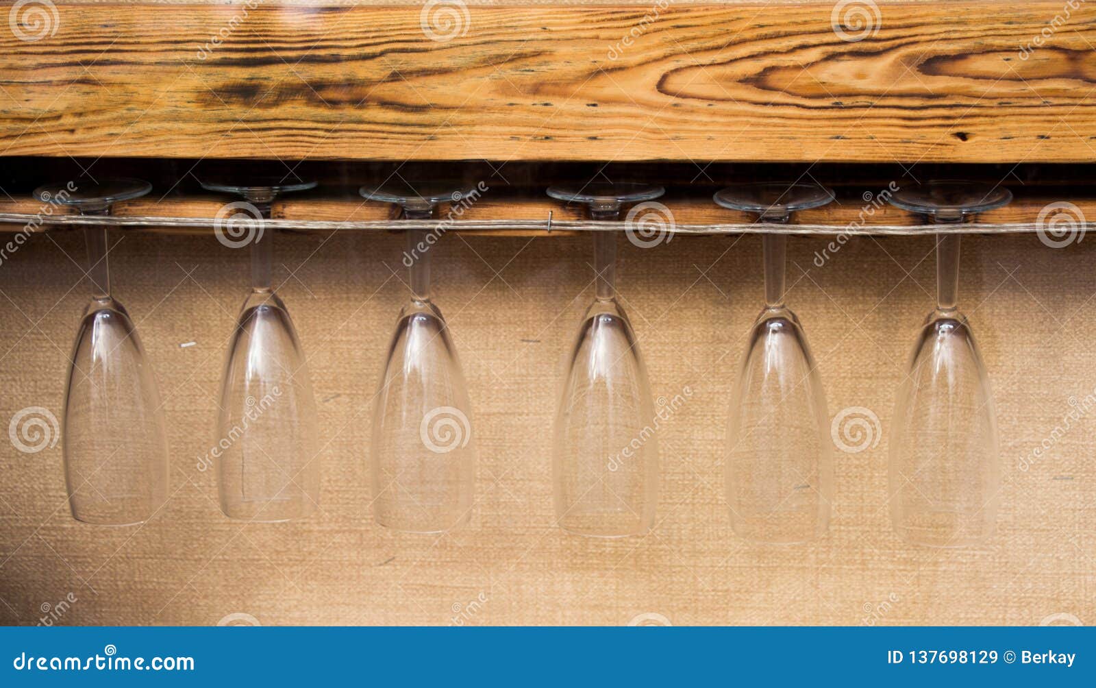 Glass Cups Hanging from a Wooden Platform on Display Stock Image ...