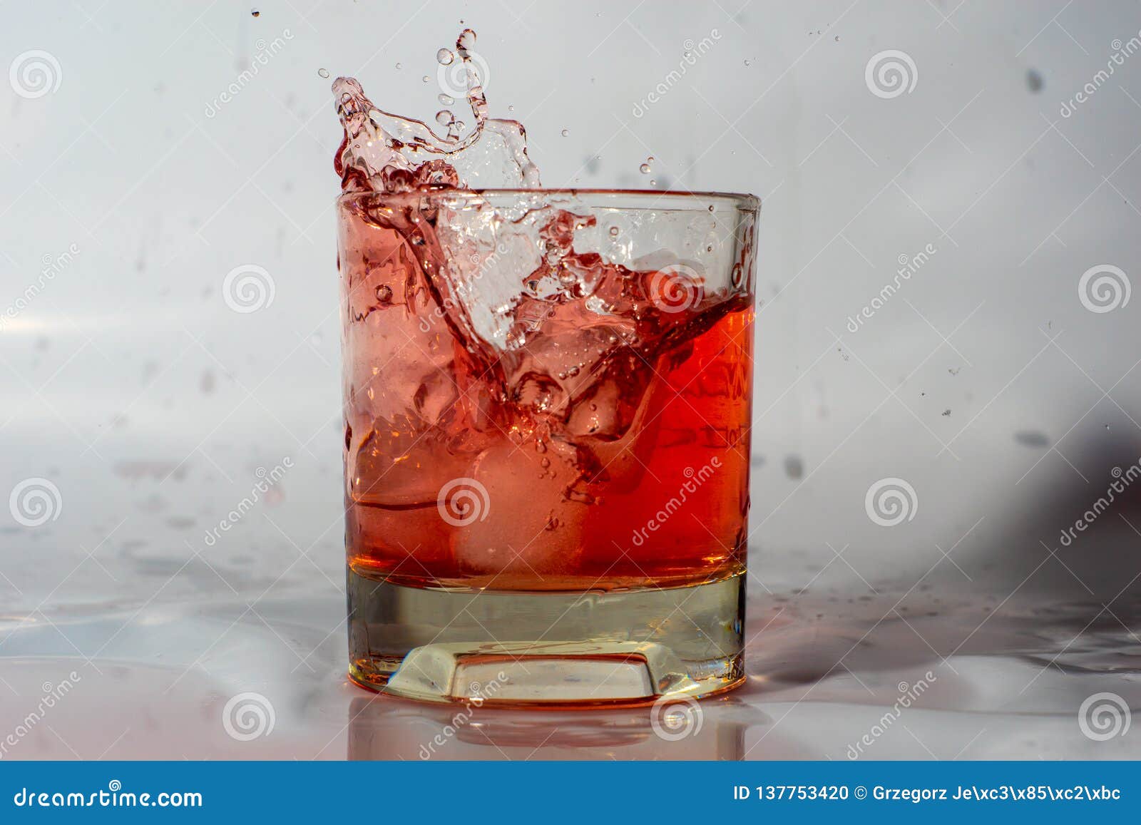 A Glass with a Drink and Ice. Ice Falling in Stock Photo - Image of ...