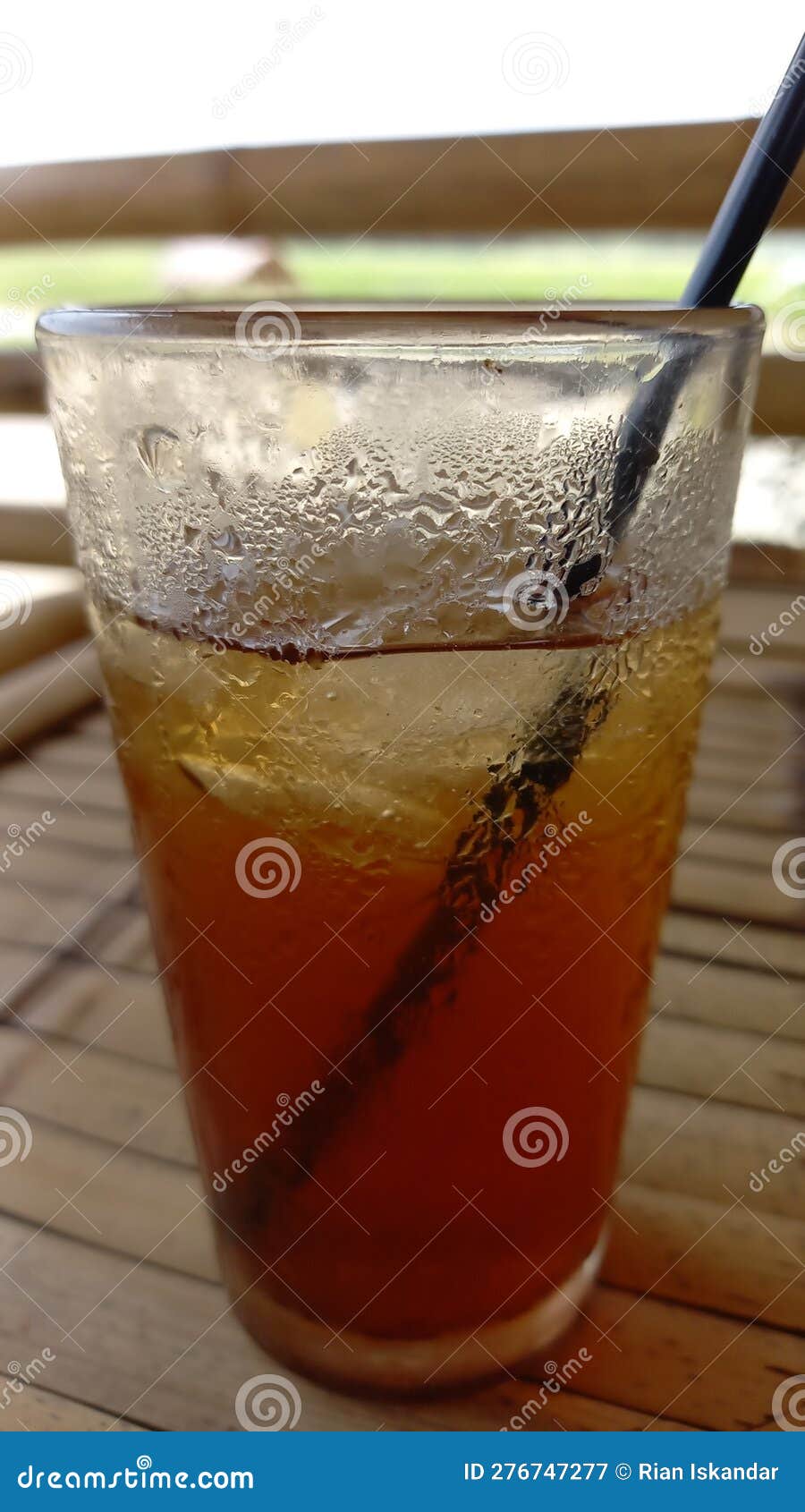 A Glass Filled with Cold Sweet Iced Tea on a Bamboo Table Stock Image ...