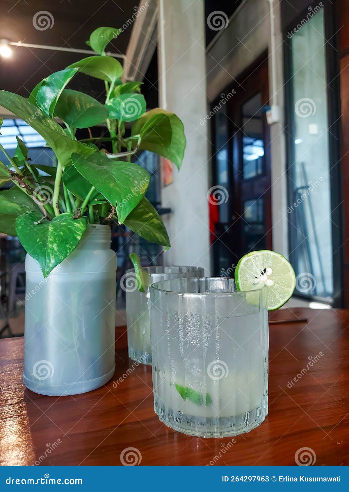 A Glass of Fresh Lime Drink Squeezing with Chugs of Ice Cubes and Lime ...