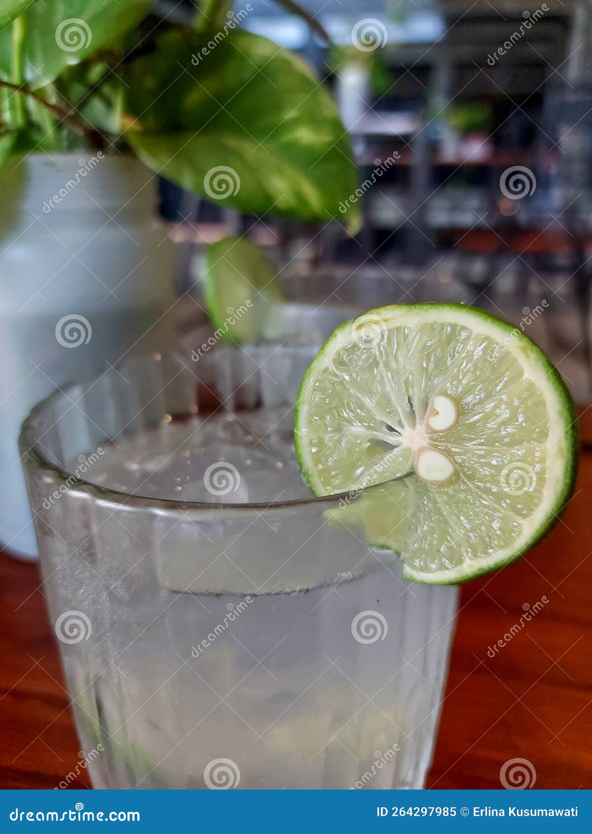 A Glass of Fresh Lime Drink Squeezing with Chugs of Ice Cubes and Lime ...