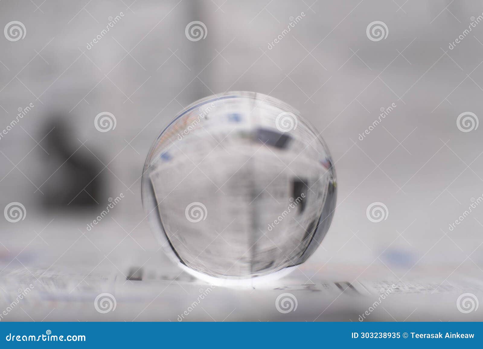A Glass Globe Reveals the Letters Inside, with a Newspaper in the ...