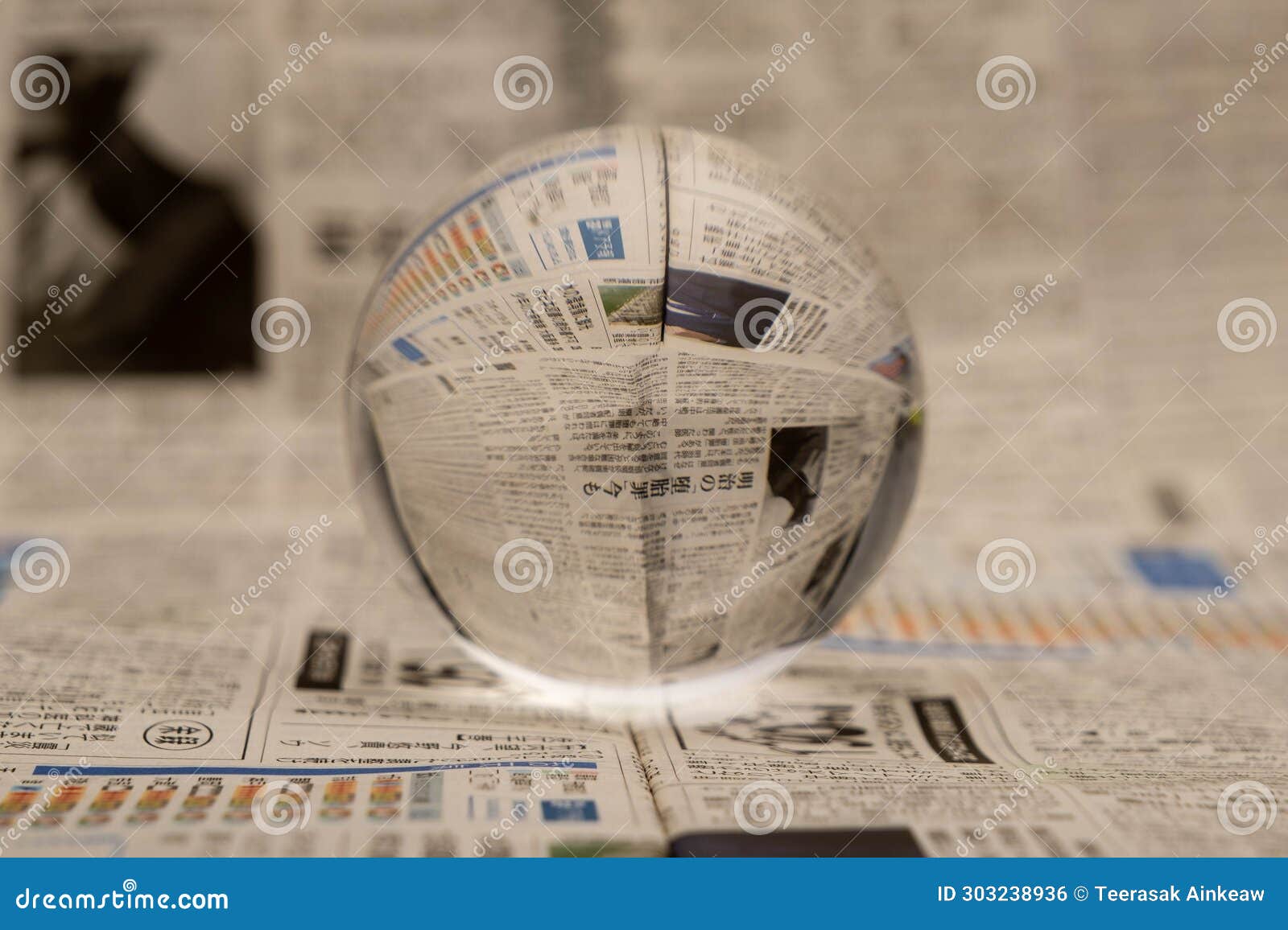 A Glass Globe Reveals the Letters Inside, with a Newspaper in the ...