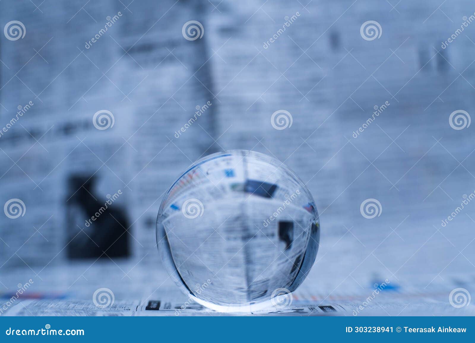 A Glass Globe Reveals the Letters Inside, with a Newspaper in the ...