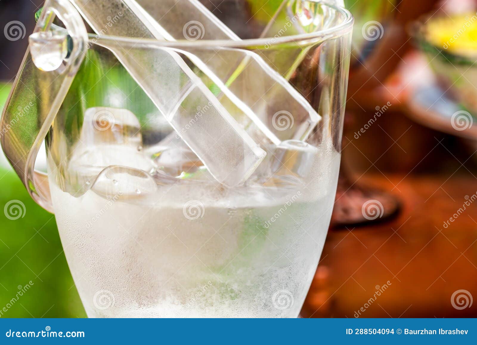 Glass Ice Bucket at a Tropical Caribbean Beach. Taking Ice Cube from ...