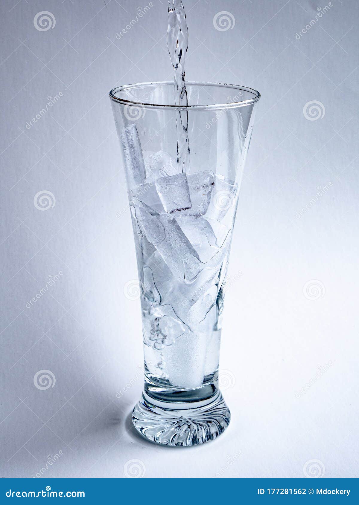 A Glass of Ice Water Being Filled Stock Photo - Image of stream ...