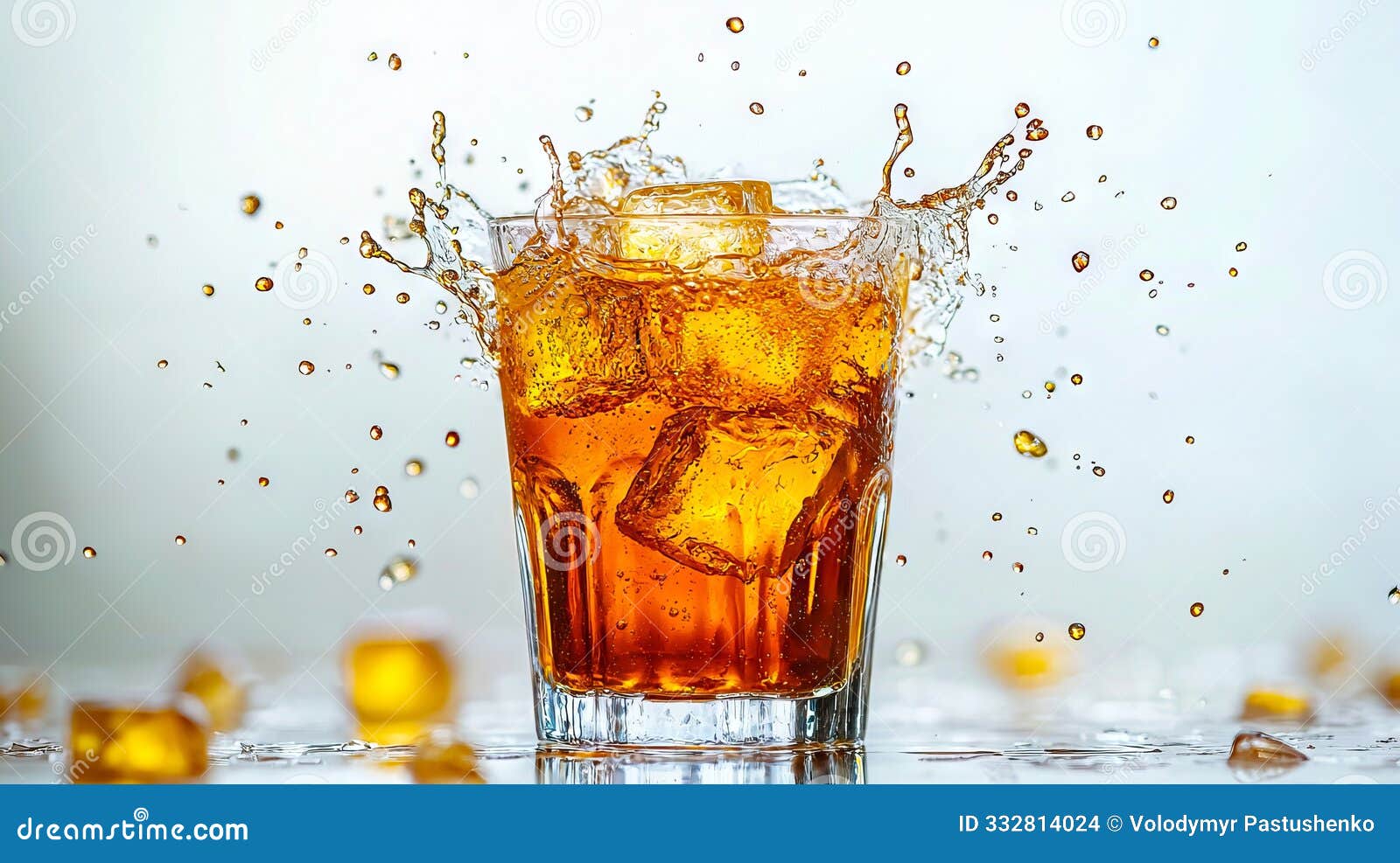 A Glass of Iced Tea with Ice Cubes Splashing Out of it Stock Photo ...
