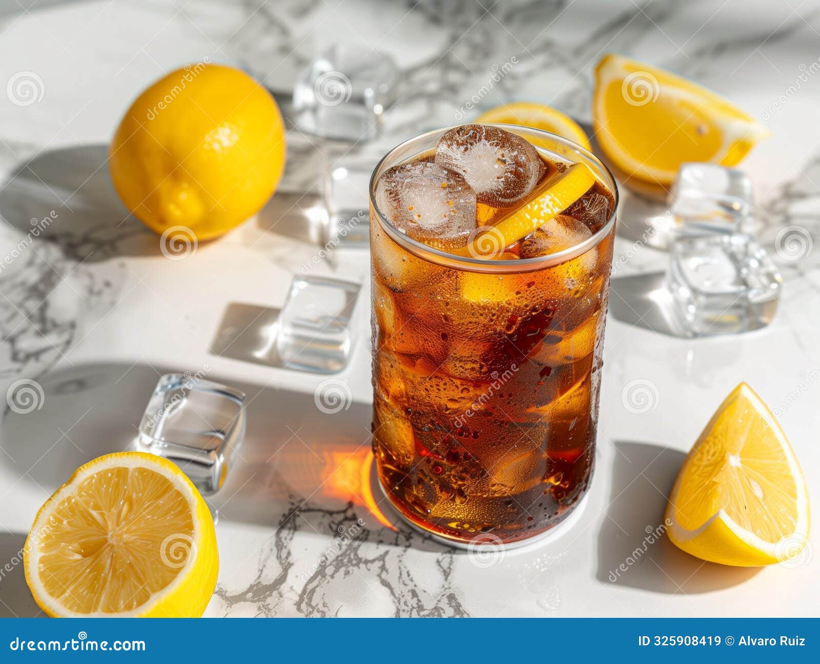 A Glass of Iced Tea with a Lemon Slice in it Sits on a Table with a Few ...