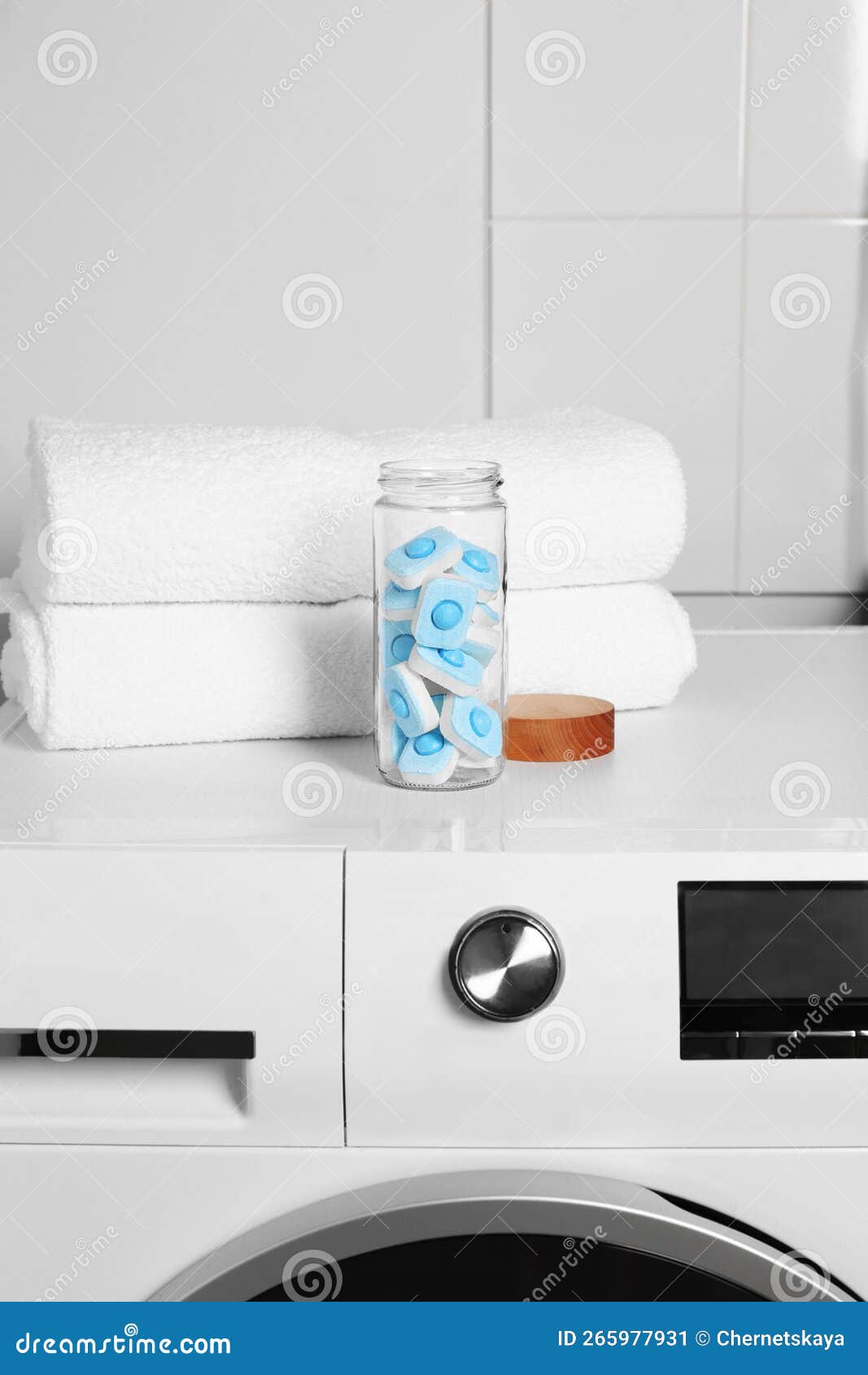 Glass Jar with Water Softener Tablets on Washing Machine in Bathroom ...