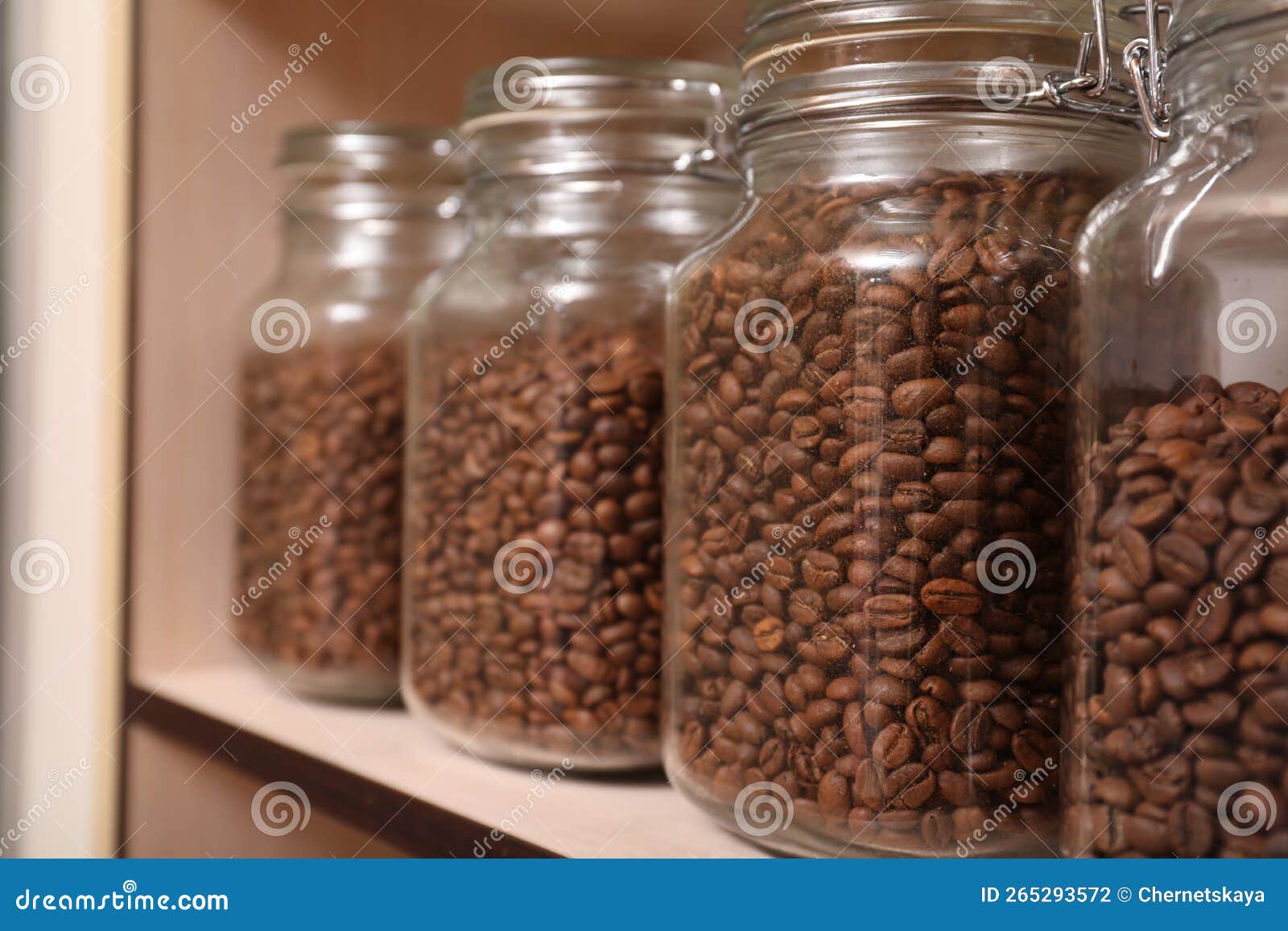 Glass Jars with Coffee Beans on Rack, Space for Text Stock Photo ...