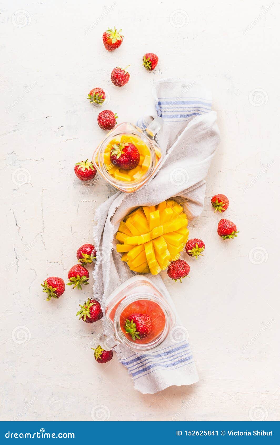Glass Jars with Yogurt Pudding, Mango and Strawberries on White Table ...