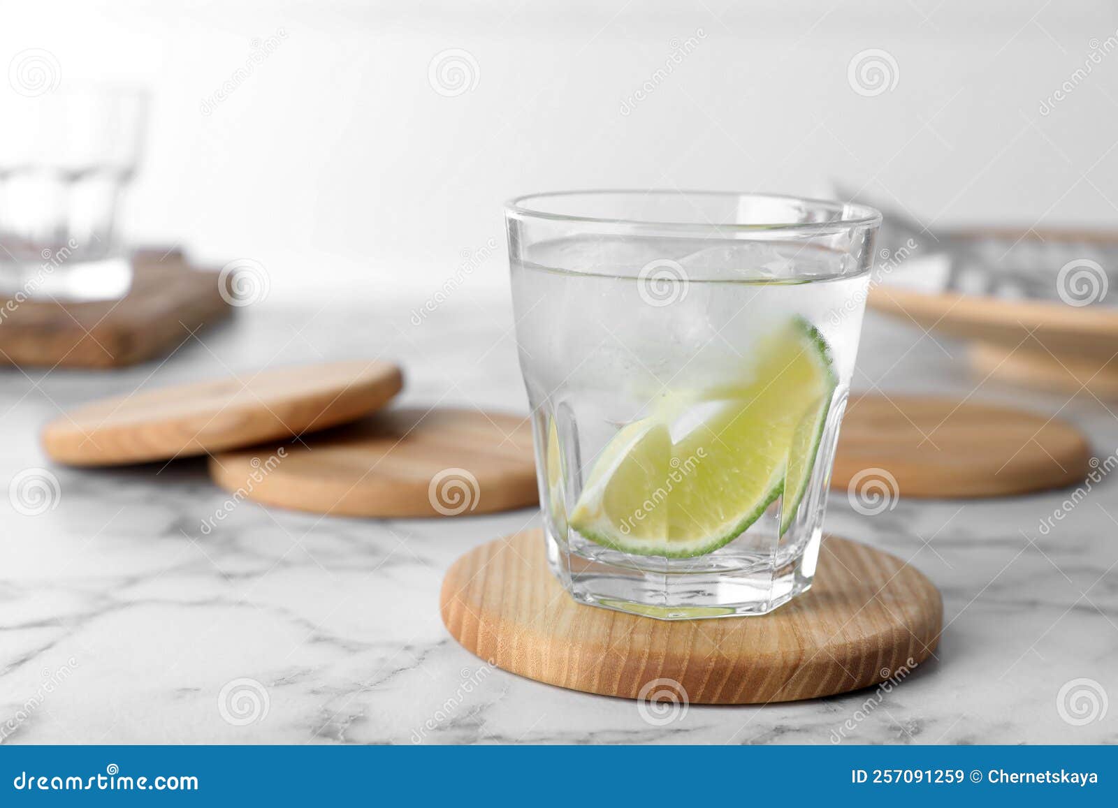 Glass of Lemonade with Stylish Cup Coasters on Marble Table at White ...