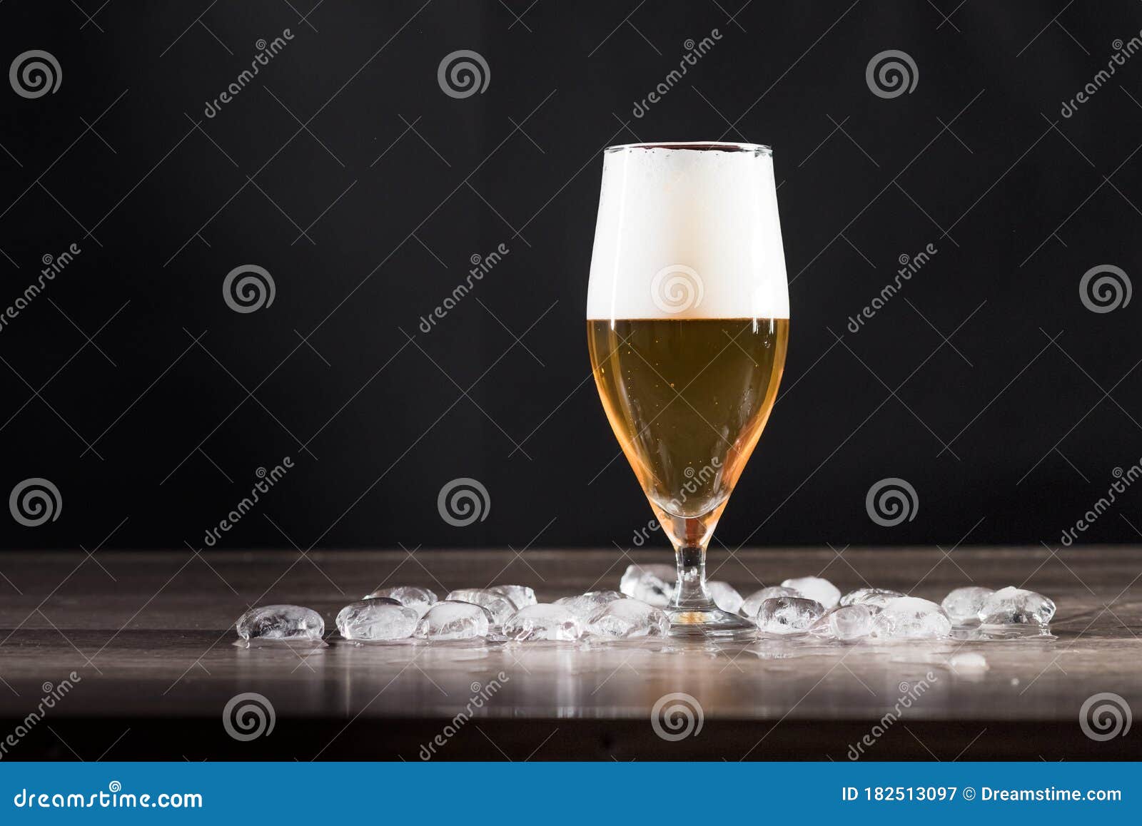 A Glass of Light Beer is on the Table with Ice. the Concept of ...