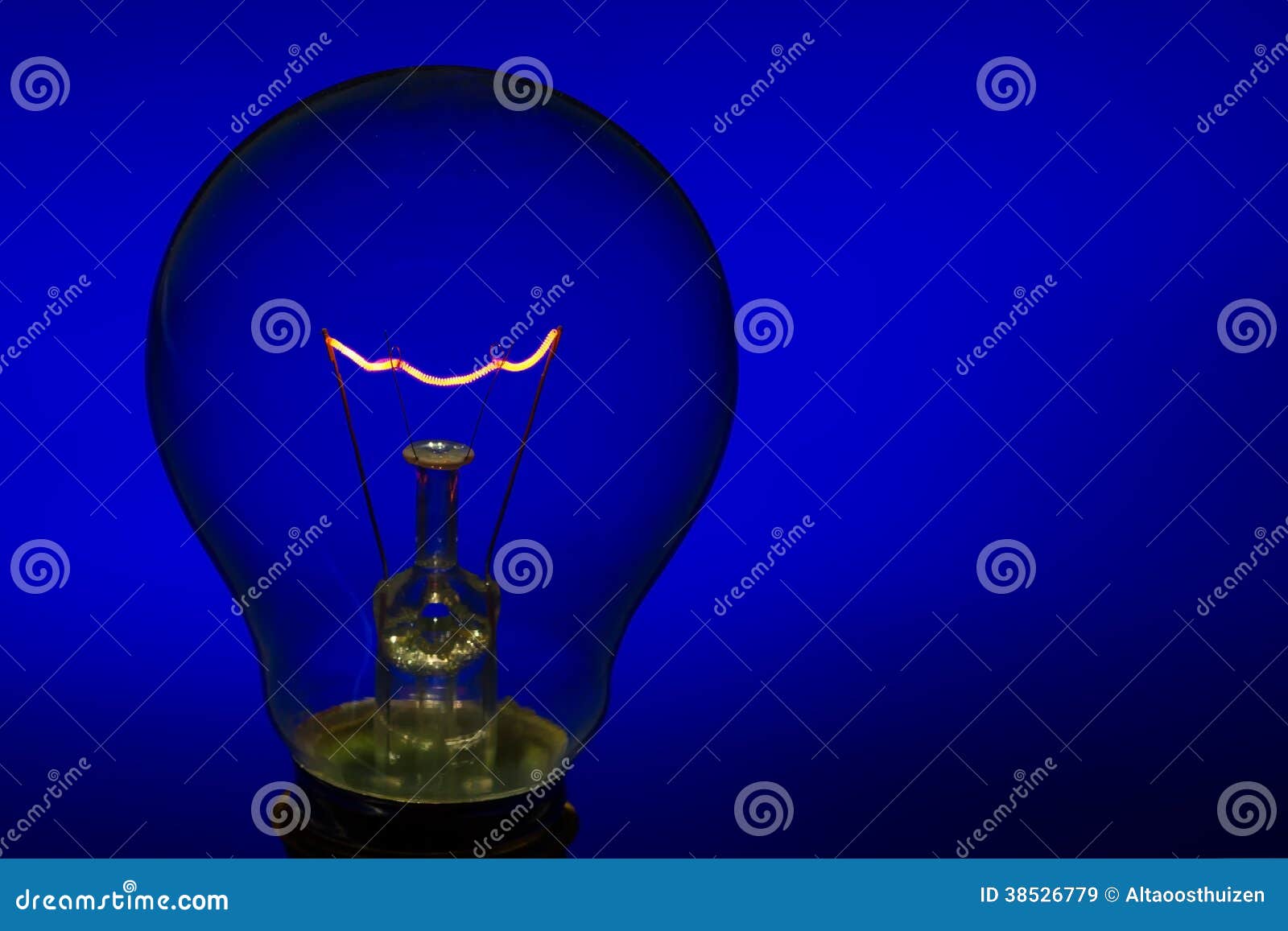 Glass Light Bulb with Burning Filament Upright with Blue Background ...
