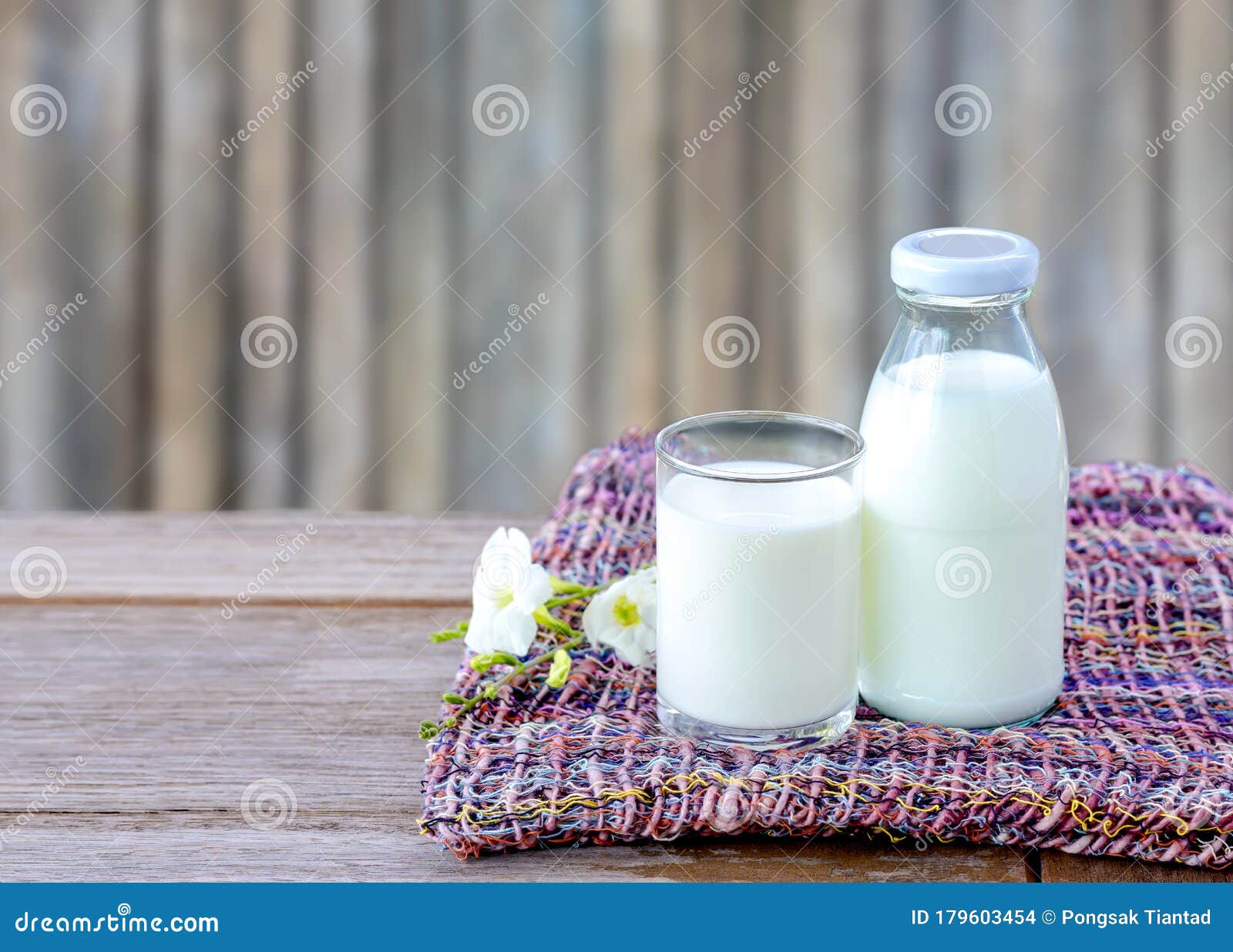 Glass of Milk and Bottle of Milk on the Wood Table with Copy Space for ...