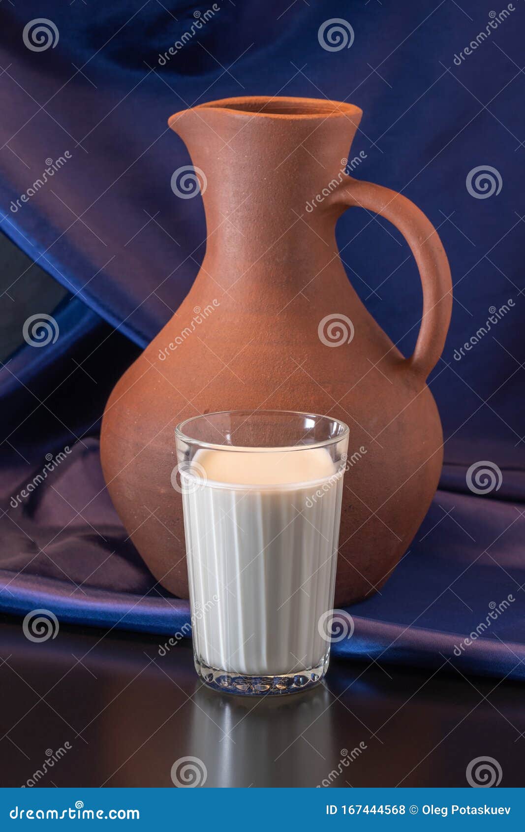 A Glass Of Milk And A Clay Jug On A Background Of Blue Drapery Stock ...