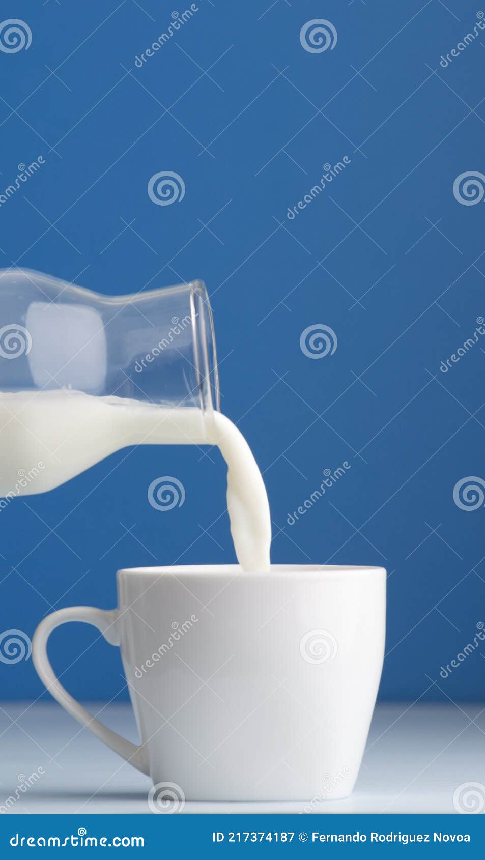 Glass of Milk Half Full, with Glass Bottle, Blue Background Stock Image ...