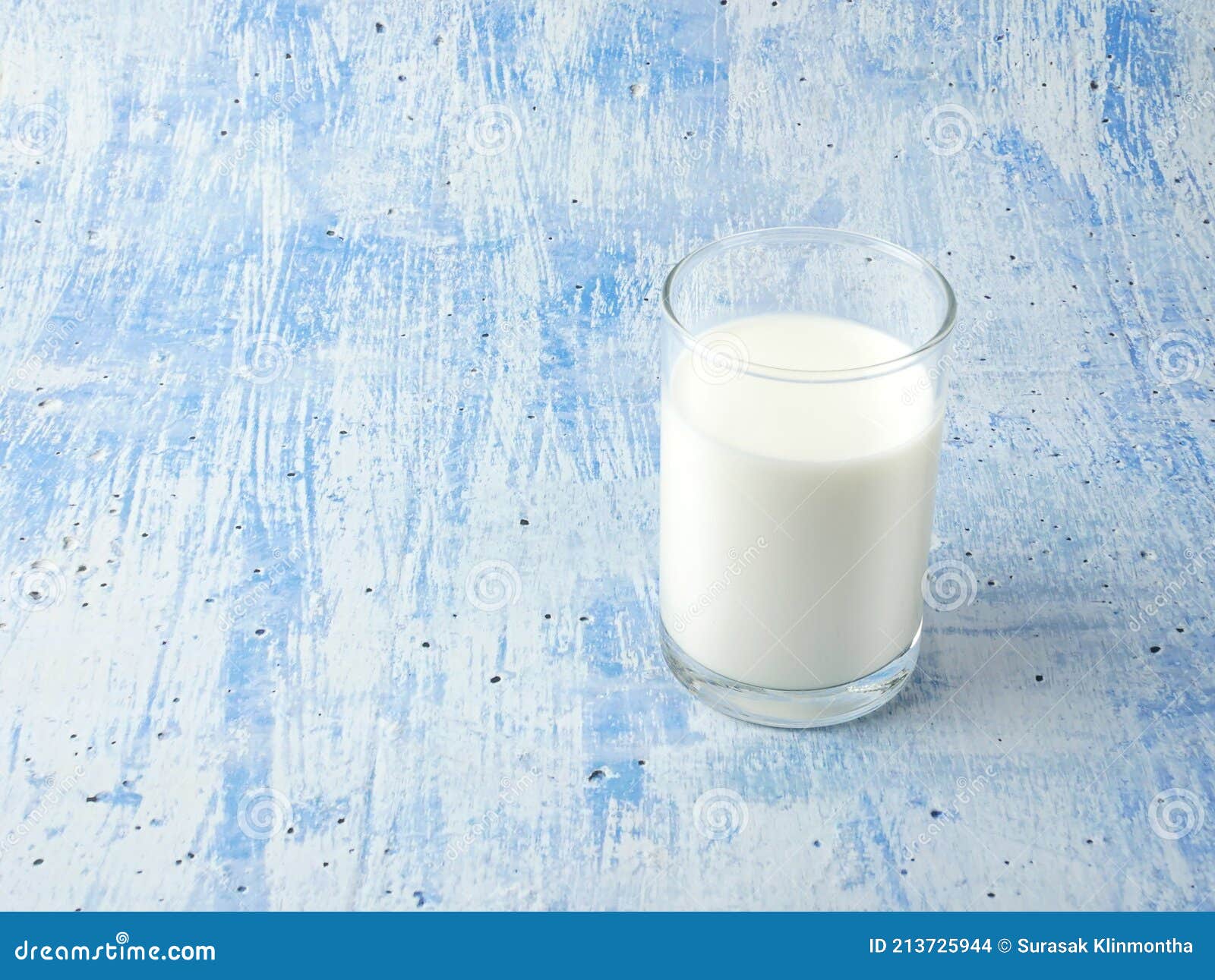 A Glass of Milk on Blue Texture Background Stock Photo - Image of ...