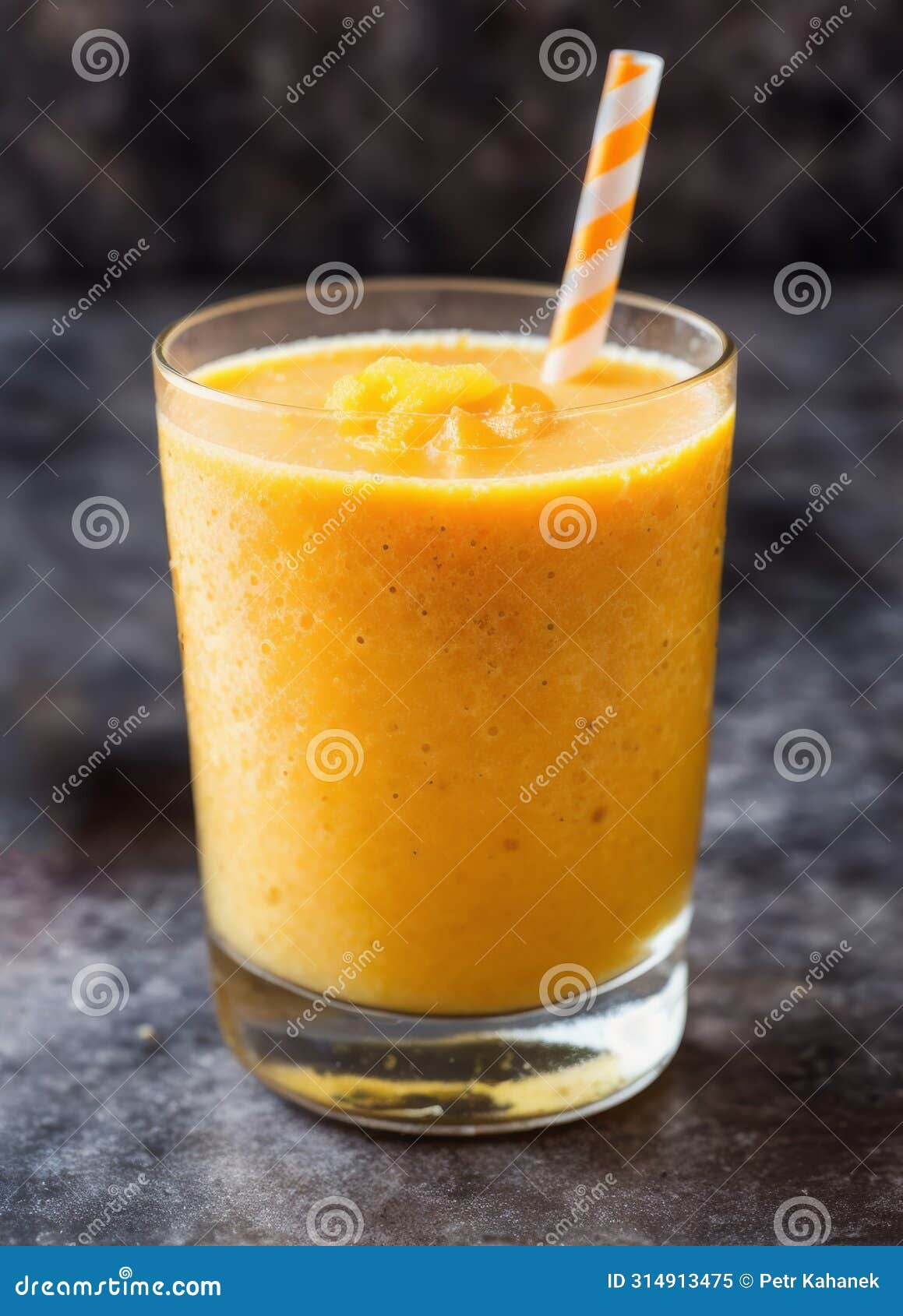 Glass of Orange Mango Smoothie with Mango Chunks, Orange Slices, and ...