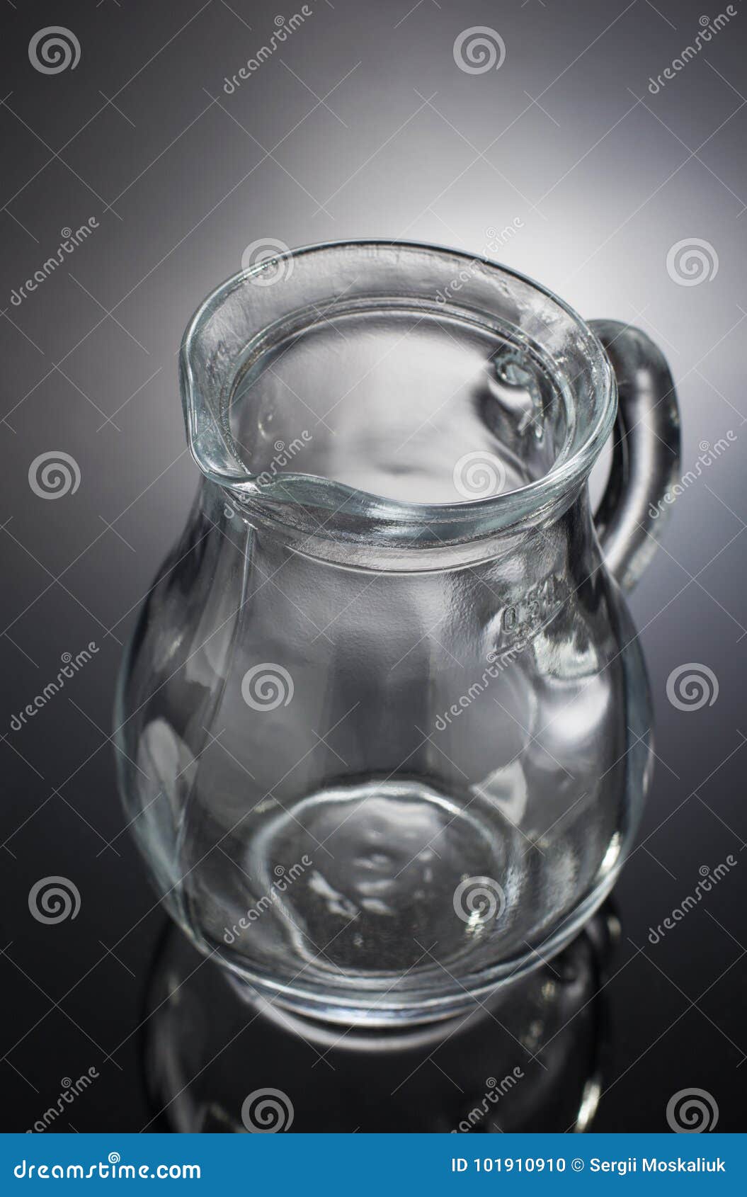 Glass pitcher on black stock photo. Image of flower - 101910910