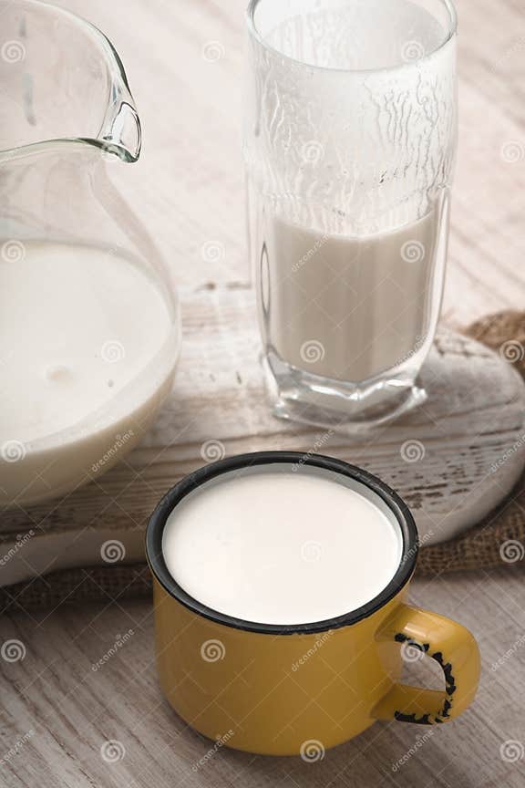 Glass and Pitcher of Kefir and Cup on a White Stand Stock Image - Image ...