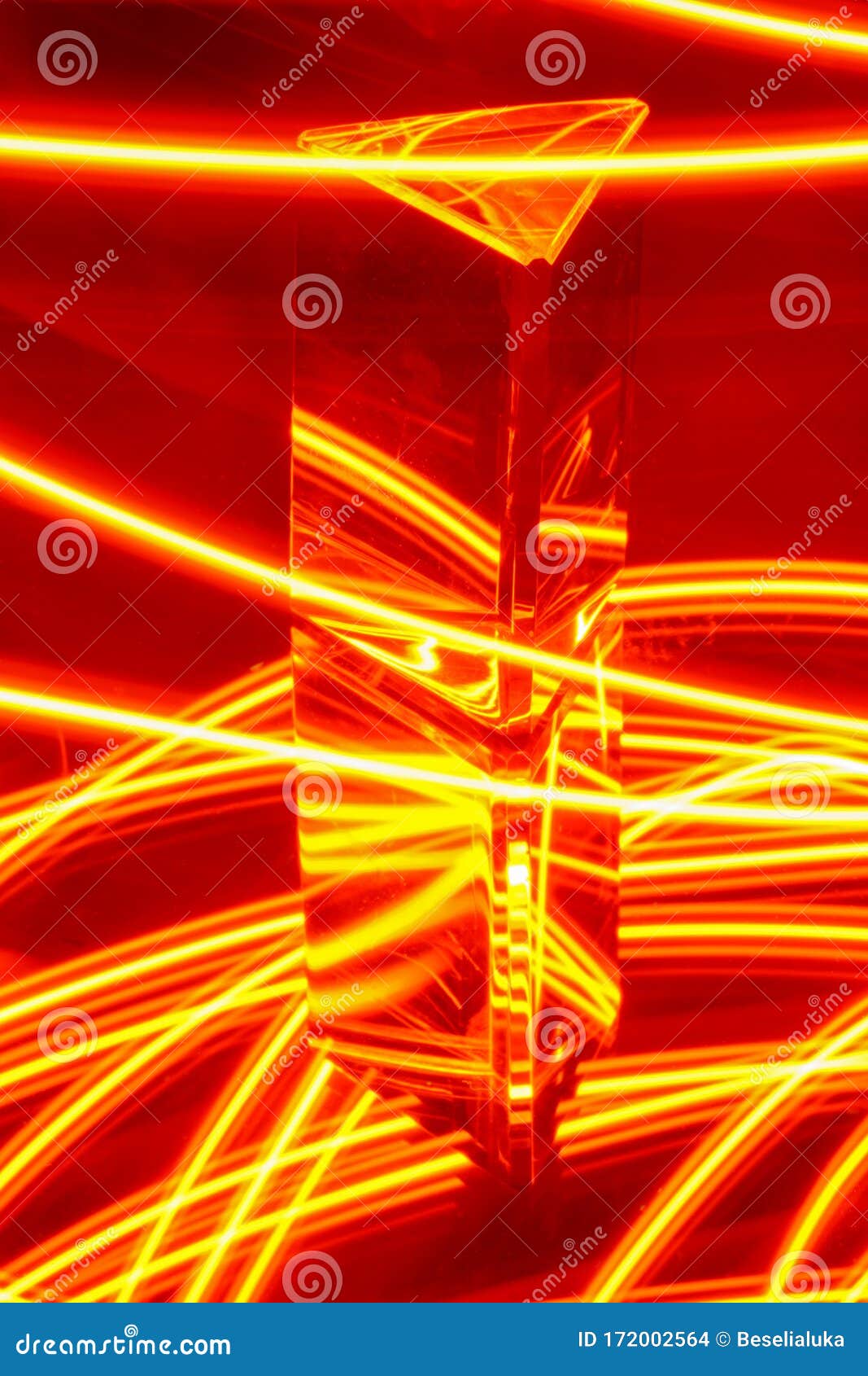 Glass Prism with Reflection on a Abstract Red and Yellow Neon ...
