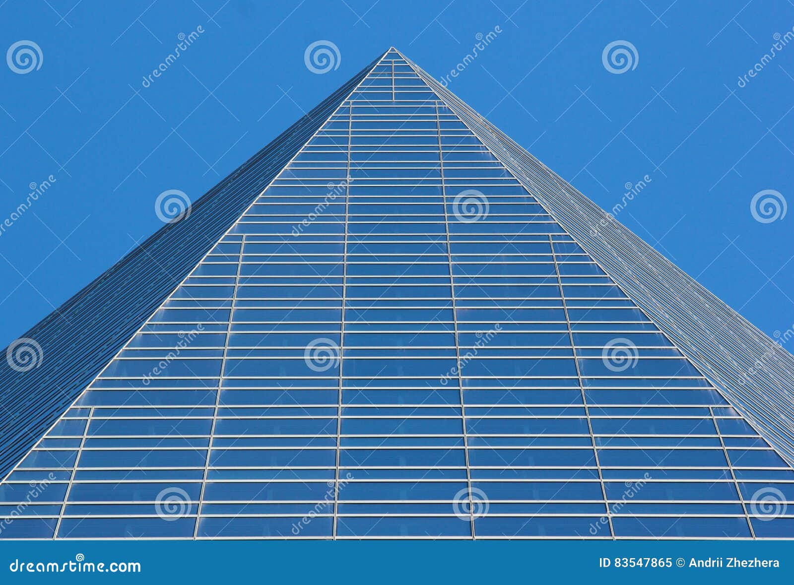 Glass Pyramid Top of a Skyscraper Against Blue Sky Background Stock ...