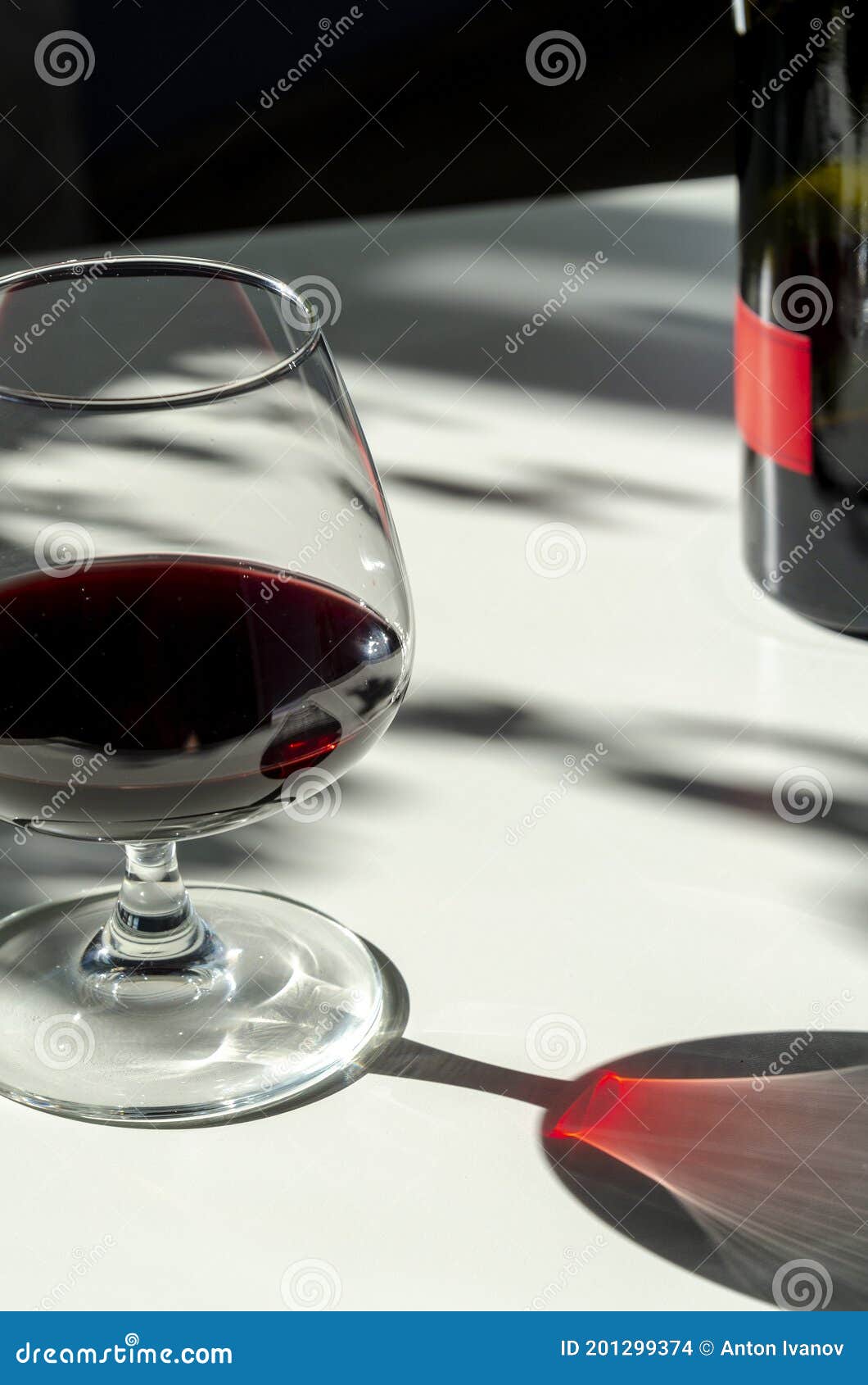 Glass of Red Ruby Port Wine on White Table with Shadows Stock Photo ...