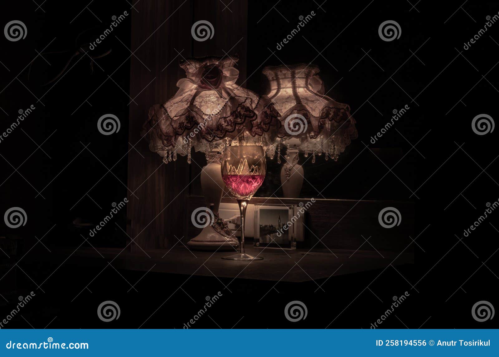 A Glass of Red Wine in the Dim Light of Vintage Lamp with Reflection ...